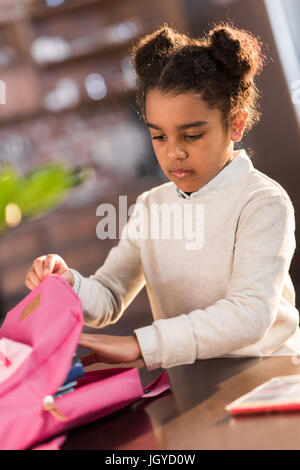 Girl preparing backpack Stock Photo - Alamy
