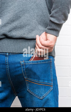 man holding a purse with money Stock Photo - Alamy