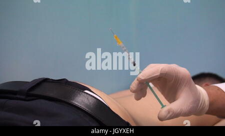 the doctor prepares the injection in the buttock Stock Photo - Alamy