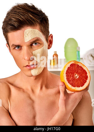 Facial mask from fresh fruits and clay for man concept. Face with ...
