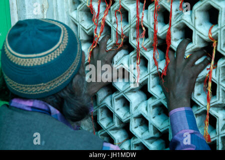 Muslim praying at the tomb or Dargah of the Sufi Saint Tawakkal Mastan ...