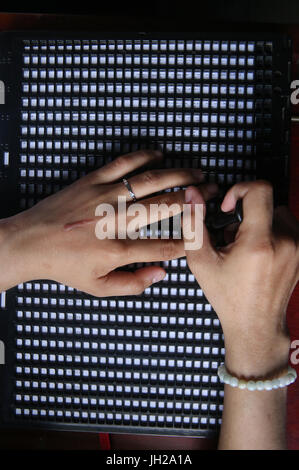 Vietnam. center for blind children. girl writing braille. sister ...