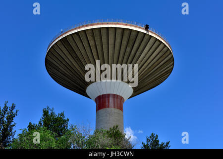 Saucer shaped concrete water tower behind trees in Latina in the Lazio ...