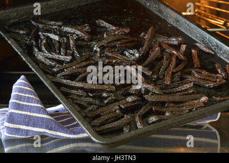 Burnt oven cooked french fries Stock Photo - Alamy
