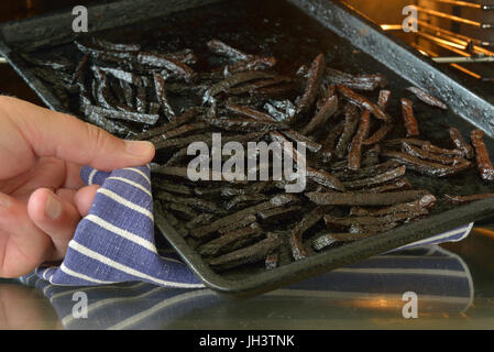Burnt oven cooked french fries Stock Photo - Alamy