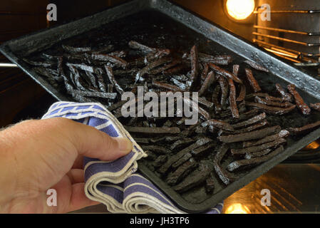 Burnt oven cooked french fries Stock Photo - Alamy