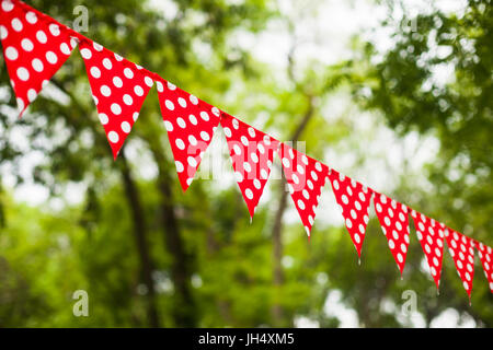 Red triangular flags with white dots on the nature background Stock ...