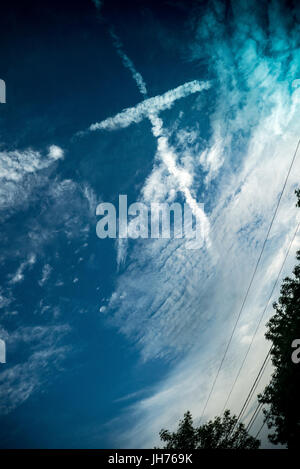 two contrails cross in the evening sky creating a dramatic "cross Stock ...
