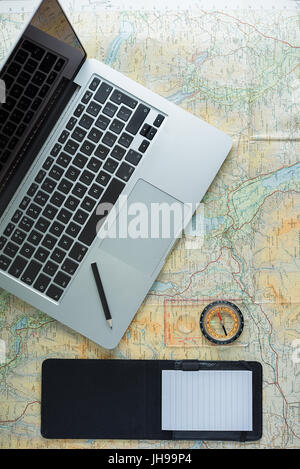 Laptop,map and compass and a notepad Stock Photo - Alamy
