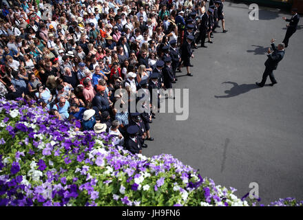Spectators are led into the grounds on day six of the Wimbledon ...