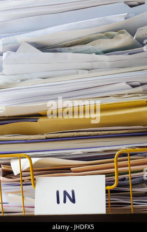office in tray piled high with a large amount of overwhelming work good ...