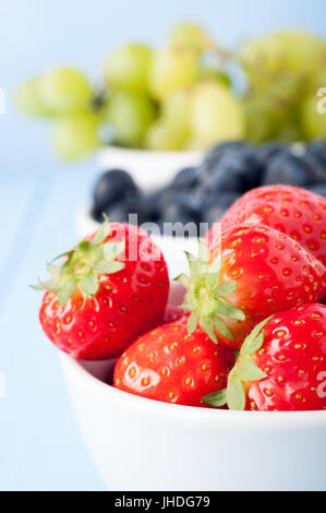 White and blue ceramic bowls on a wood table Stock Photo - Alamy