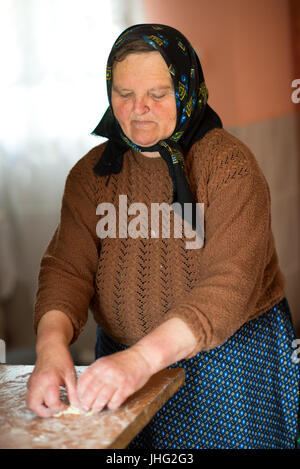 An old woman preparing food, Breb, Maramures, Romania Stock Photo - Alamy