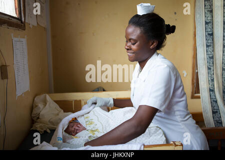 A nurse, doing some early checks on a new born baby at hospital, Uganda ...