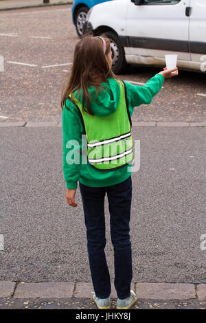 Young women handing up water to road runners Stock Photo - Alamy