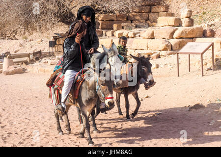 Bedouin men riding horses in the desert in Saudi Arabia Stock Photo - Alamy