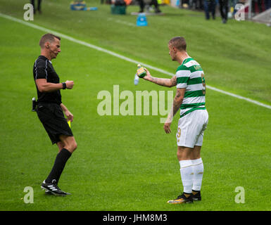 Celtic striker Leigh Griffiths shows the referee an empty bottle of ...