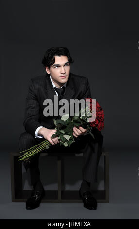 young men waiting date with roses watching time and calling Stock Photo ...