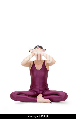 Woman practicing yoga Muktasana pose Stock Photo - Alamy