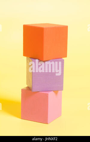 Multiple colored cubes on yellow background Stock Photo - Alamy