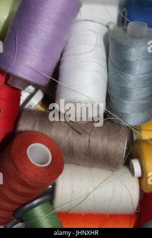 Reels of blue and white threads on white background Stock Photo - Alamy