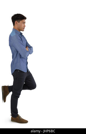 Side view of young businessman with crossed arms looking away. Full ...