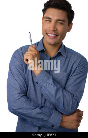 Thinking businessman holding pen against blackboard Stock Photo - Alamy