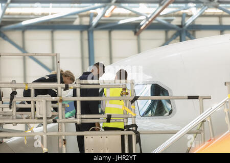 Aircraft maintenance engineers working over internal structure of an ...