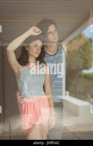 Young couple near window at home Stock Photo - Alamy