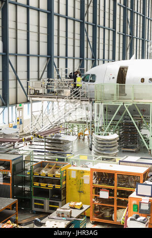 Aircraft maintenance engineers working over internal structure of an ...
