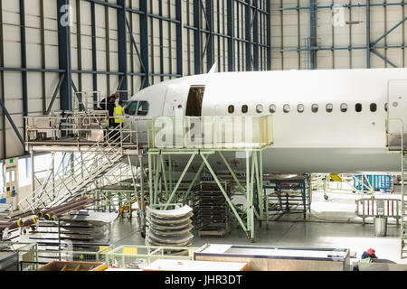 Aircraft maintenance engineers working over internal structure of an ...
