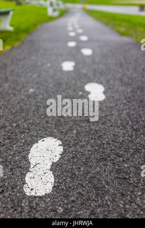 Painted footprints pattern on the pavement Stock Photo - Alamy