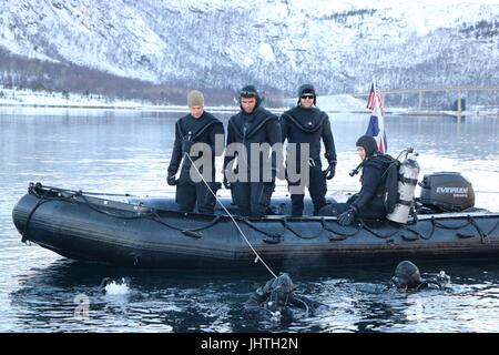 U.S. Navy commandos in dry suits scuba dive into frigid waters during ...