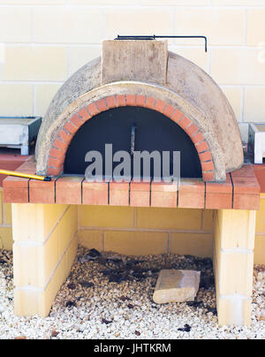 Traditional Greek and Cyprus kleftiko oven with burning fire inside ...