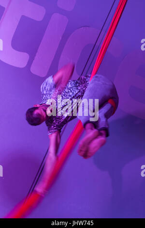 acrobats hanging on a rope by their legs Stock Photo - Alamy