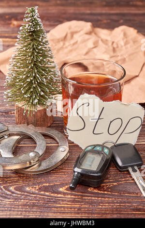 Keys, handcuffs, alcohol, new year tree Stock Photo - Alamy