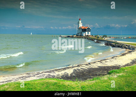Amazing lighthouse on the island of Marken and majestic beach with ...