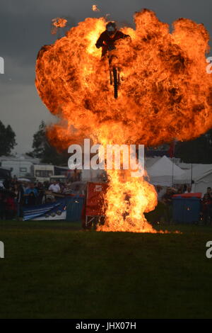 Motorcycle stunt rider jumping through explosion flames Stock Photo - Alamy