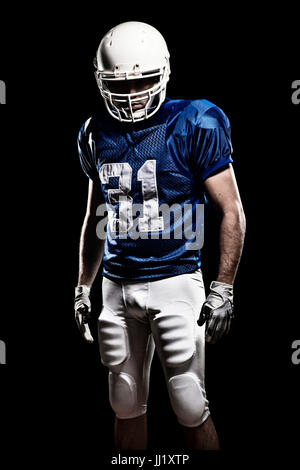 Football Player with number on a blue uniform and a ball in the hand ...