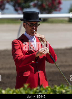 Bugler in top hat and coat plays Cal to the Post at the horse races in ...