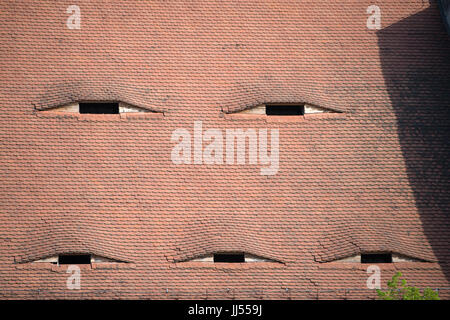 Eye-shaped windows on the tiled roofs of Sibiu, Transylvania, Romania ...