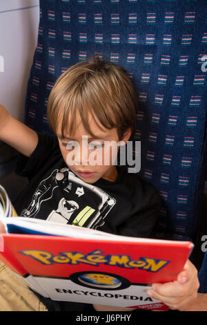 Children reading Pokemon book Stock Photo - Alamy