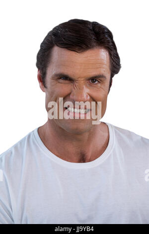 Mature man clenching teeth against black background Stock Photo - Alamy