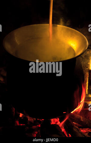 Big black pot on campfire Stock Photo - Alamy