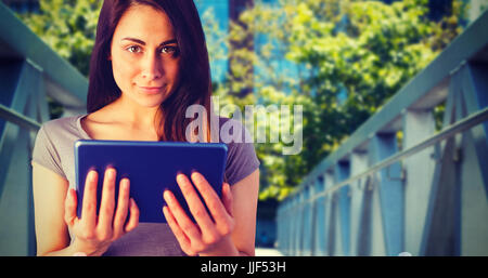 Young brunette woman over grunge grey wall wearing graduate uniform ...