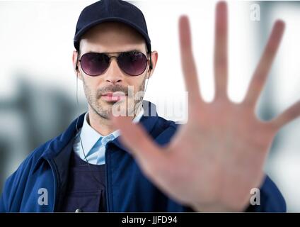Digital composite of security guard saying stop with his hand in the ...