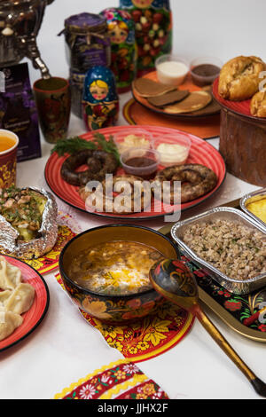 Traditional Ukrainian food borscht and dumplings on a table covered ...
