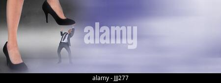 A businessman about to be stepped on by a giant foot, isolated on a ...