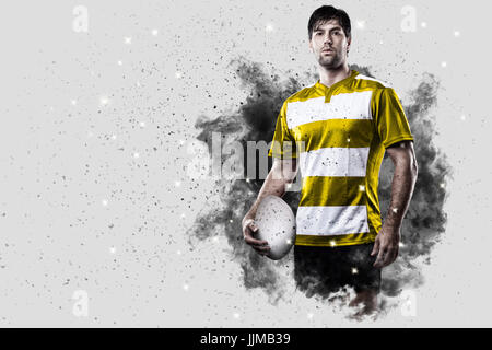 Rugby Player with a Yellow uniform coming out of a blast of smoke Stock ...