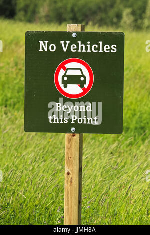 Sign: No vehicles beyond this point, with a blurry background, seen ...